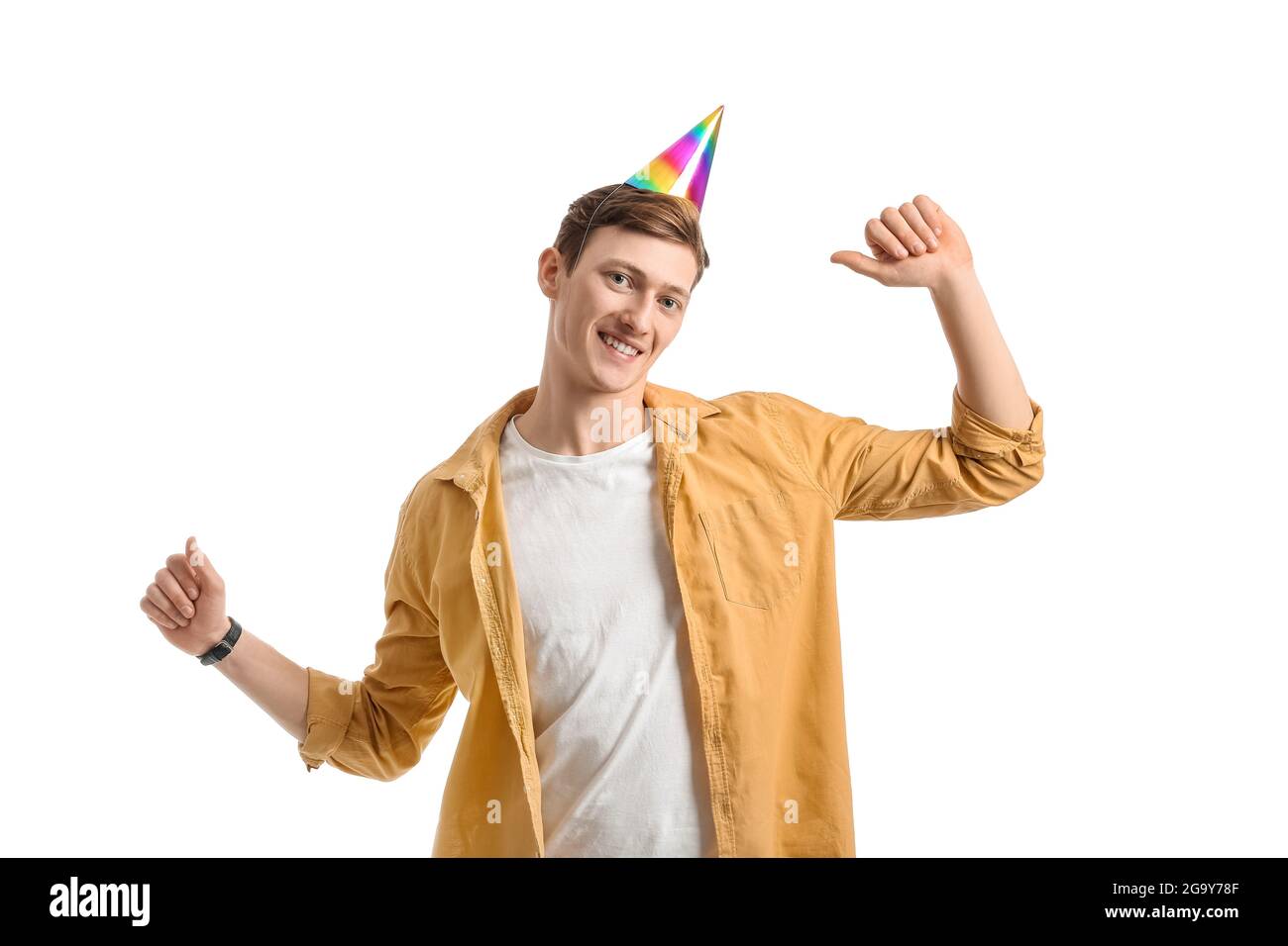 Happy young man in party hat on white background Stock Photo - Alamy