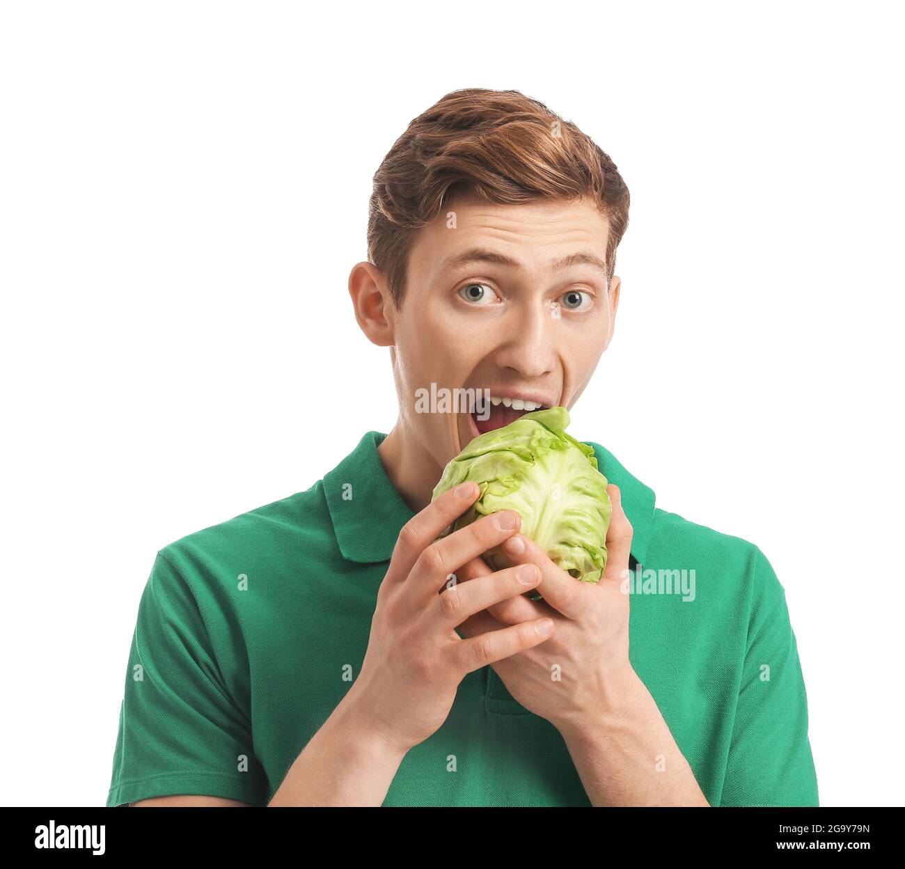 Young man eating fresh cabbage on white background Stock Photo - Alamy
