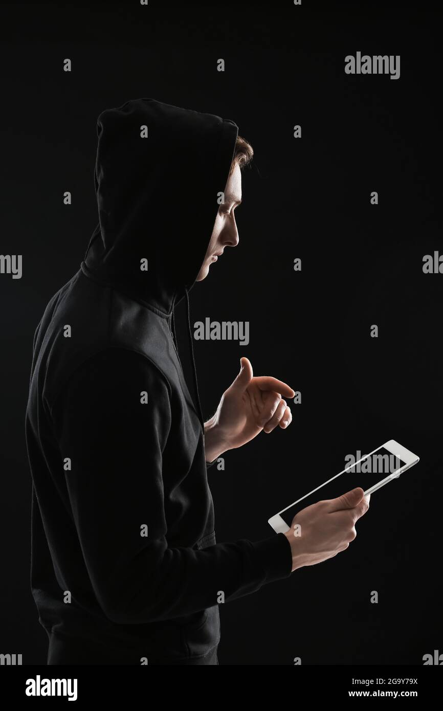 Silhouette of hacker with tablet computer on dark background Stock ...