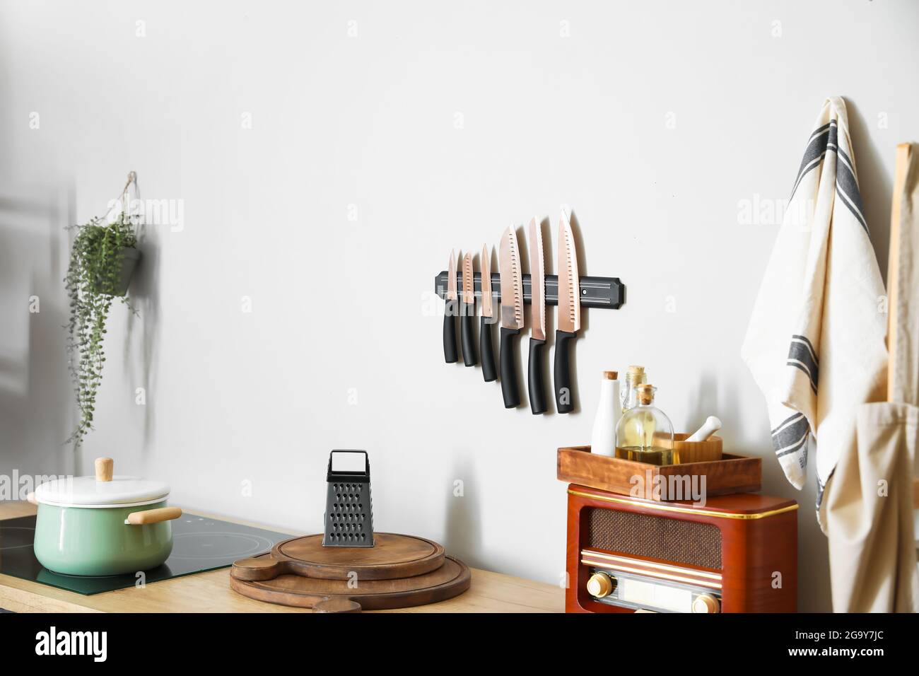 Kitchen utensils with food and retro radio receiver on counter near ...