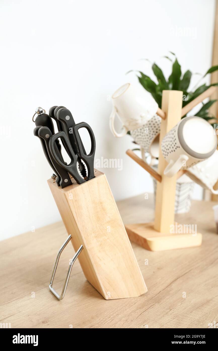 Stand with knives on table in kitchen Stock Photo - Alamy