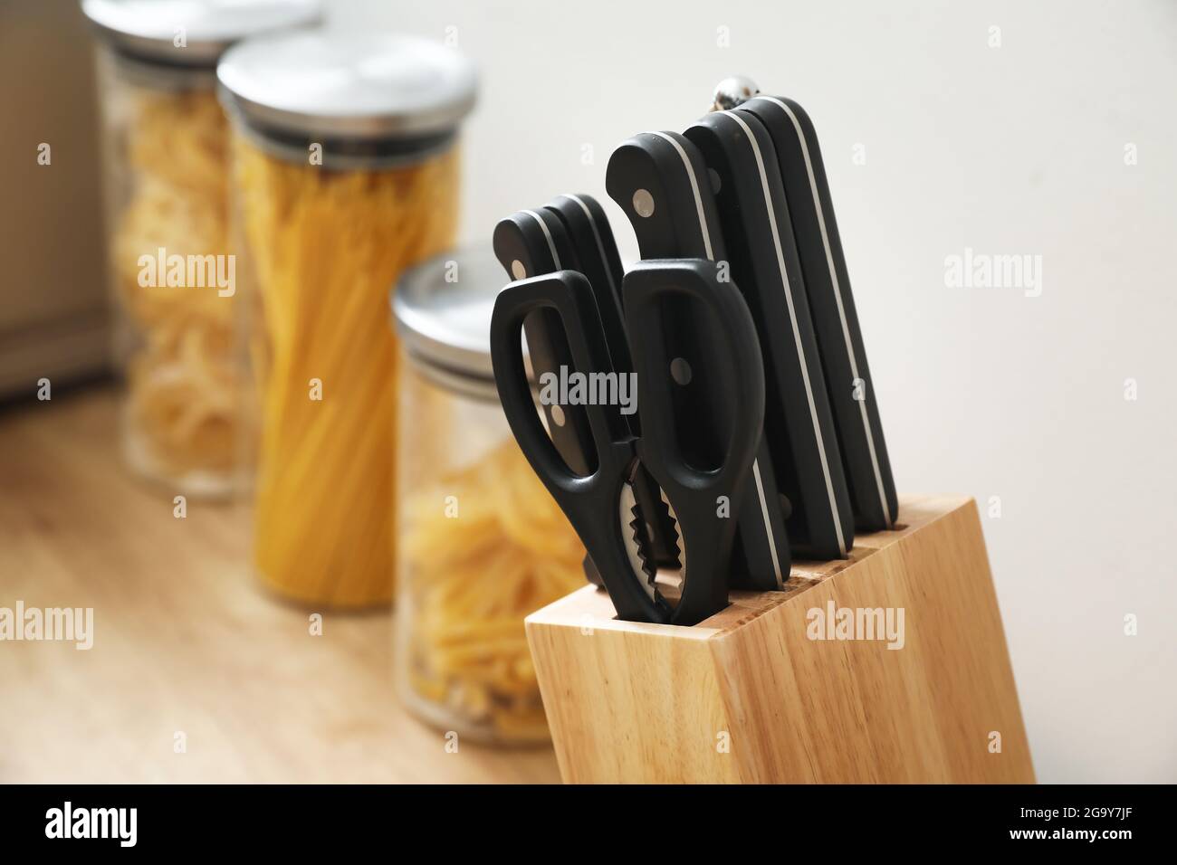 Stand with knives on table in kitchen, closeup Stock Photo - Alamy