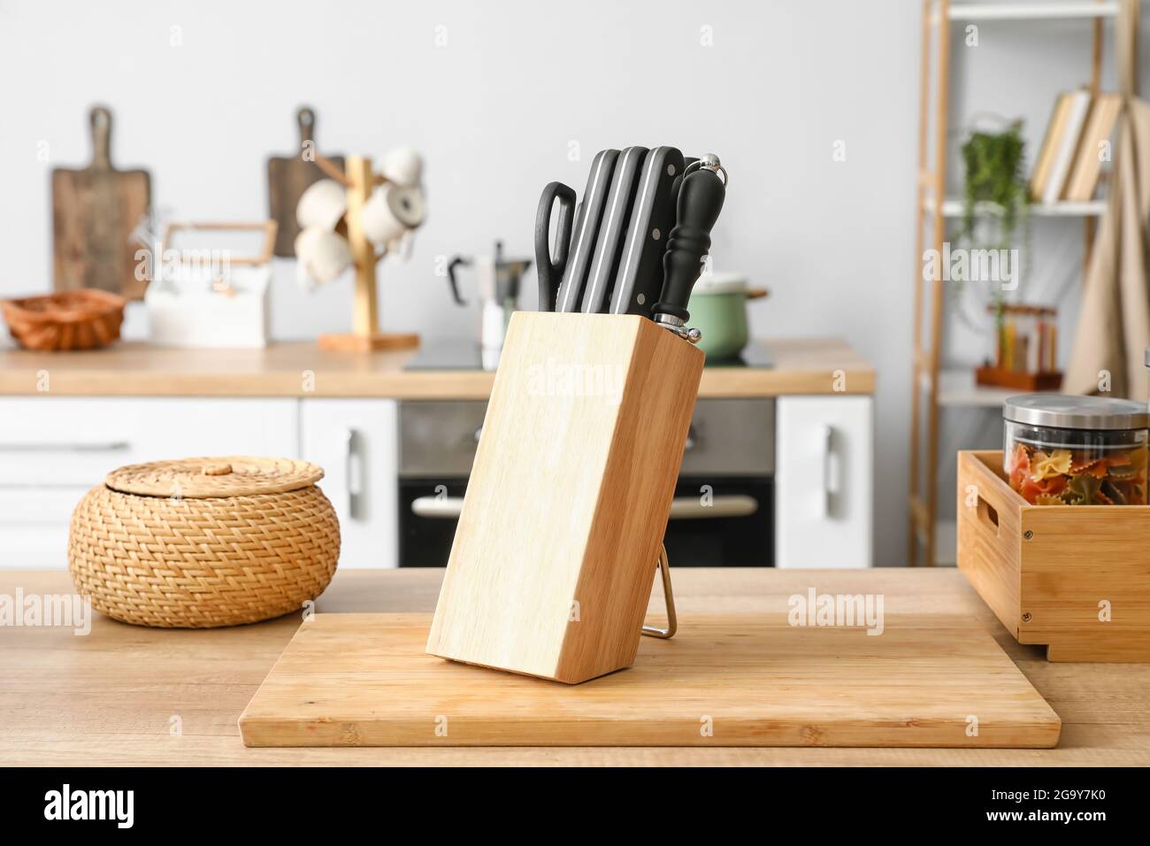 Stand with set of knives on table in kitchen Stock Photo - Alamy