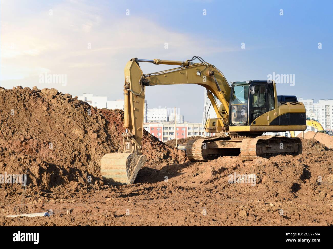 Excavator on earthworks at construction site. Backhoe on earthmoving ...