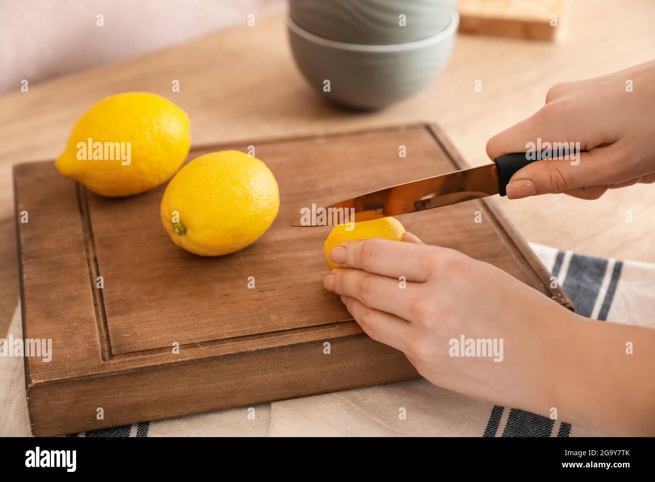 Female chef cutting lemon hi-res stock photography and images - Alamy