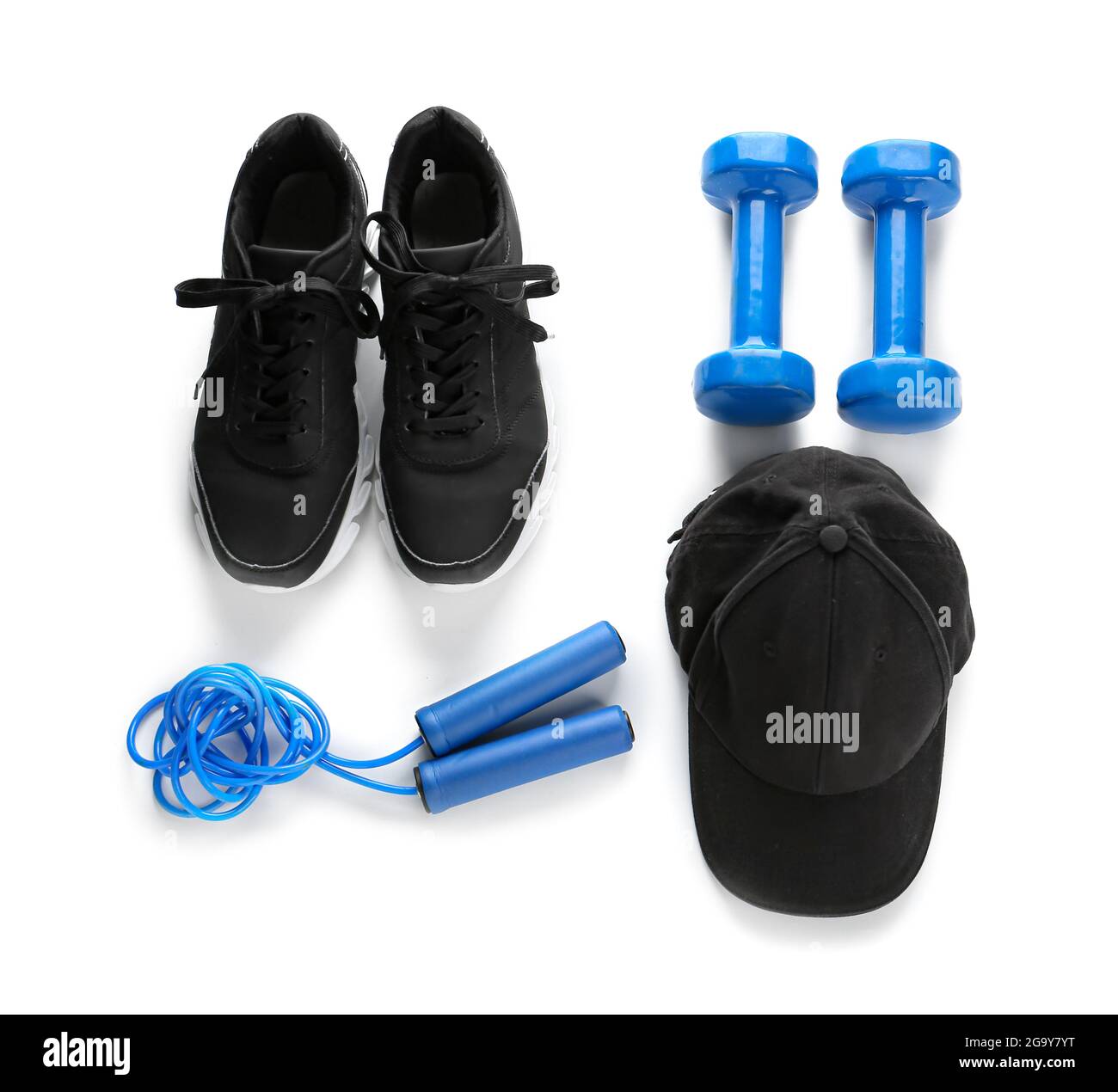 Sport shoes, cap, skipping rope and dumbbells on white background Stock ...
