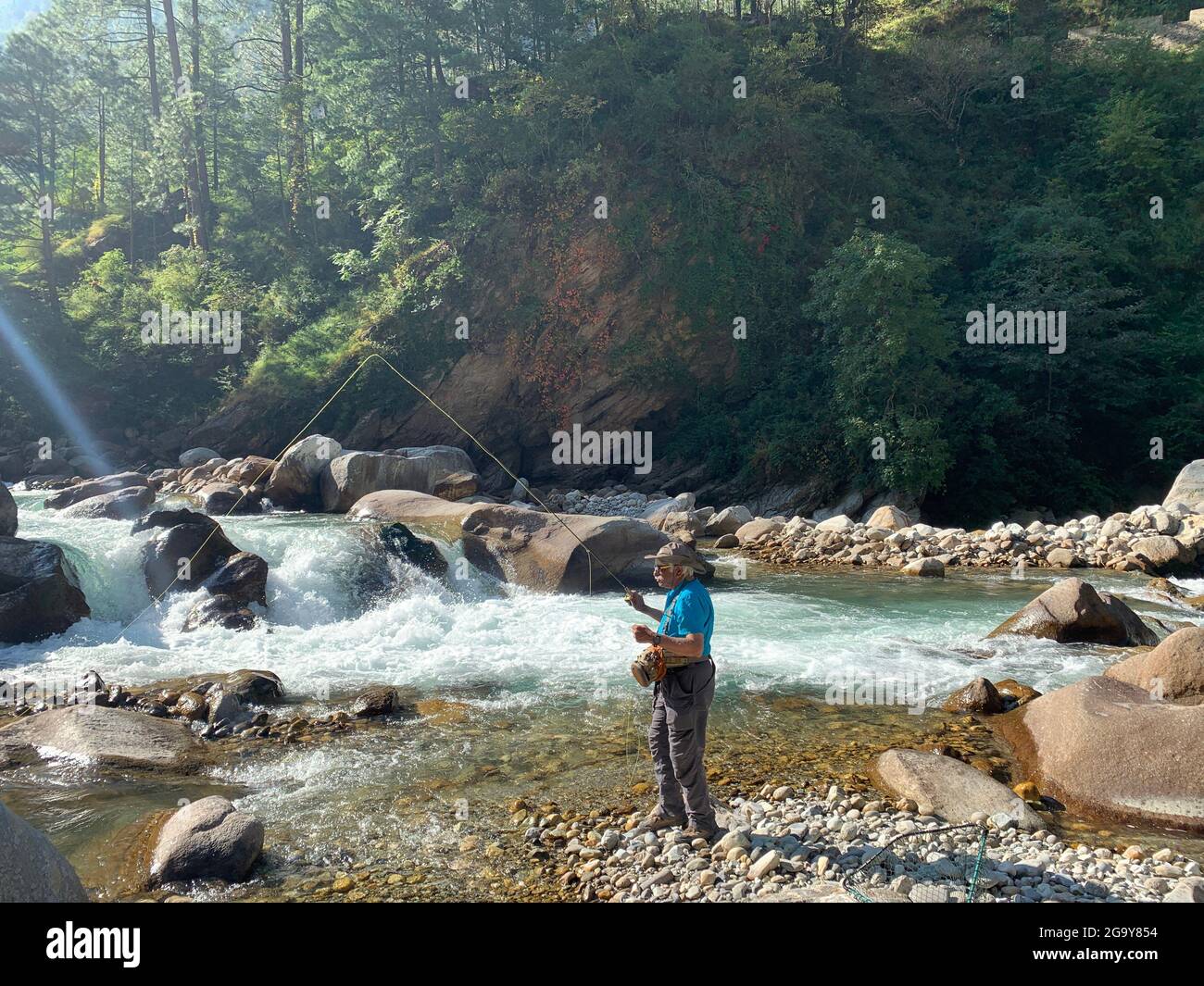 Man trout fishing in a river in the Himalayas, India Stock Photo - Alamy