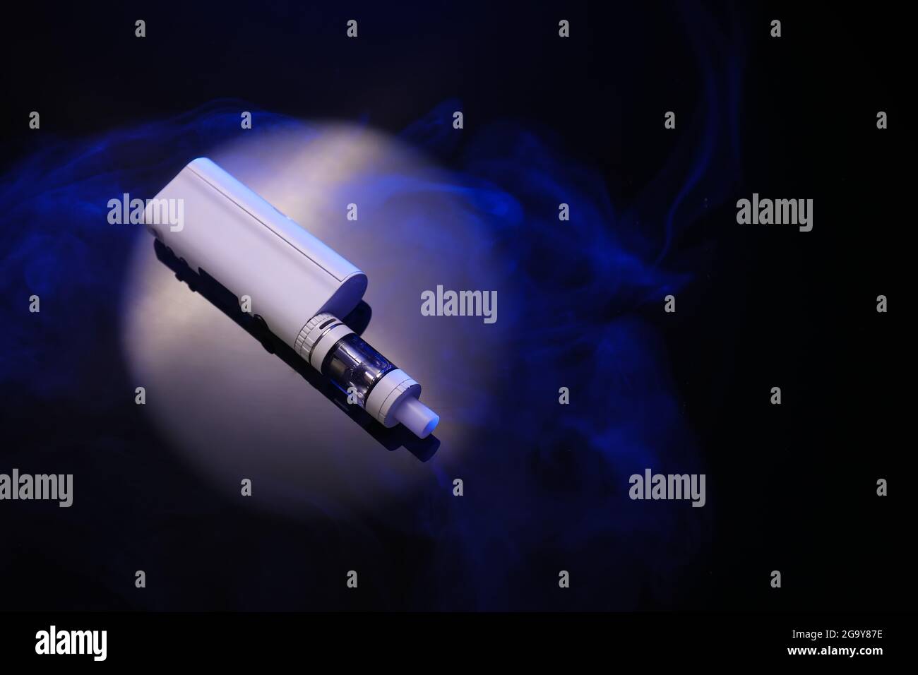 Vape mod on dark background with fume Stock Photo - Alamy