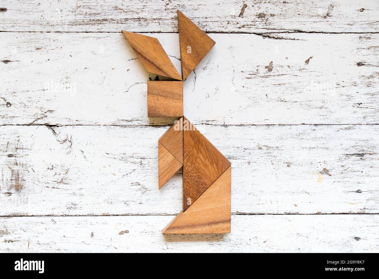 Tangram puzzle in rabbit shape on old white wood background Stock Photo ...