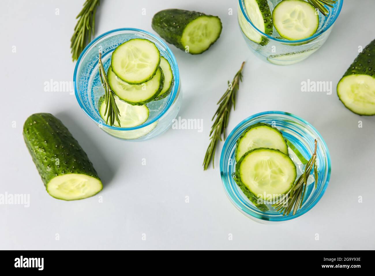 Glasses with cucumber lemonade on light background Stock Photo - Alamy