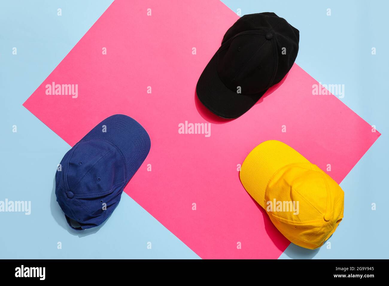 Stylish baseball hats on color background Stock Photo - Alamy