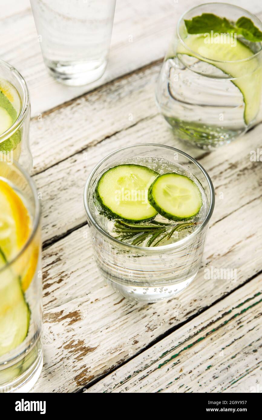 Glasses with cucumber lemonade on light wooden background Stock Photo ...