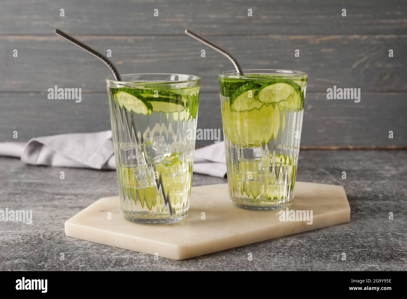 Glasses with cucumber lemonade on grey background Stock Photo - Alamy