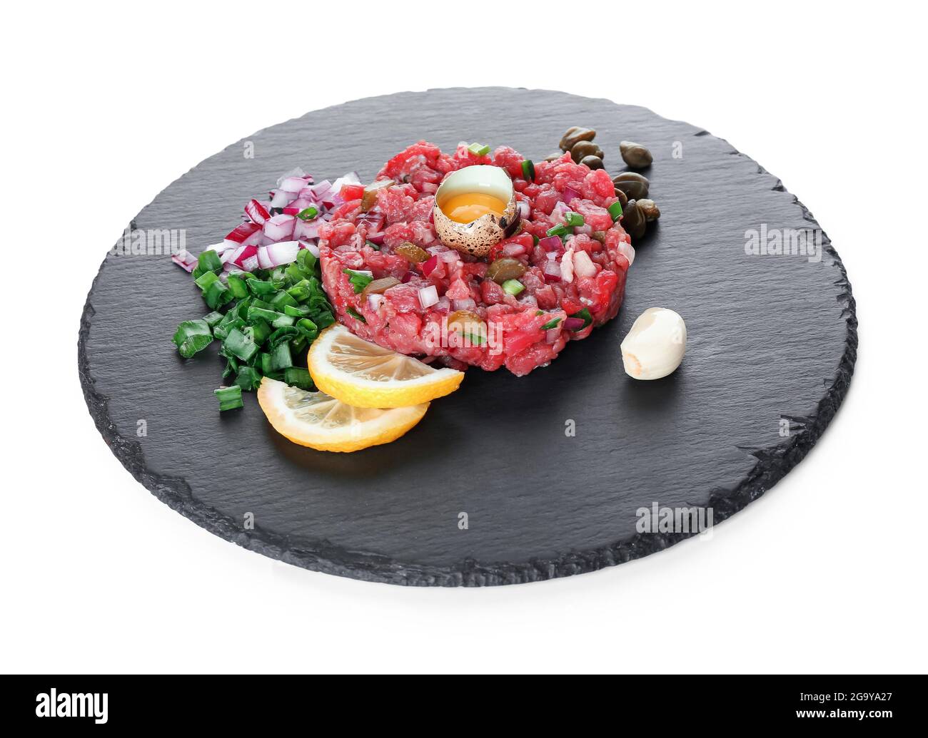 Slate plate with tasty beef and lemon tartare on white background Stock ...