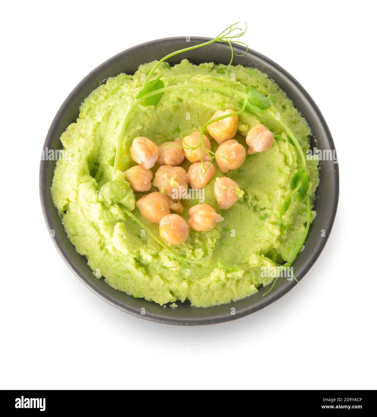 Bowl with tasty green pea hummus on white background Stock Photo - Alamy