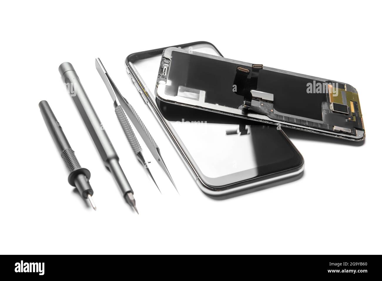 Disassembled mobile phone with technician tools on white background ...