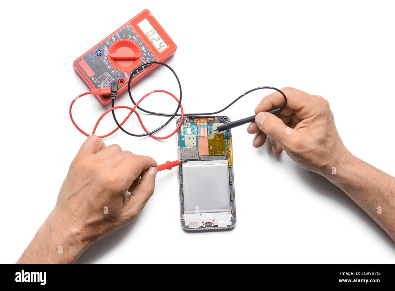 Male technician repairing damaged mobile phone on white background ...