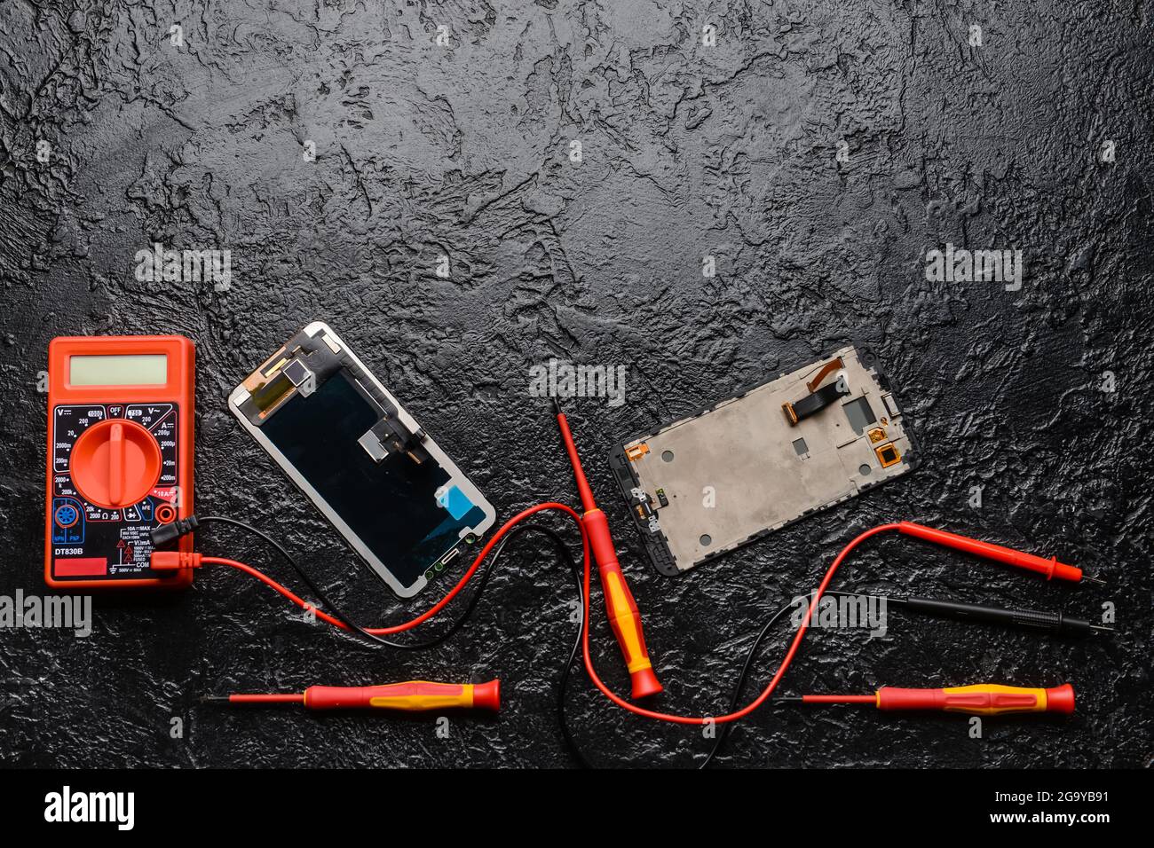 Disassembled mobile phone with multimeter on dark background Stock ...