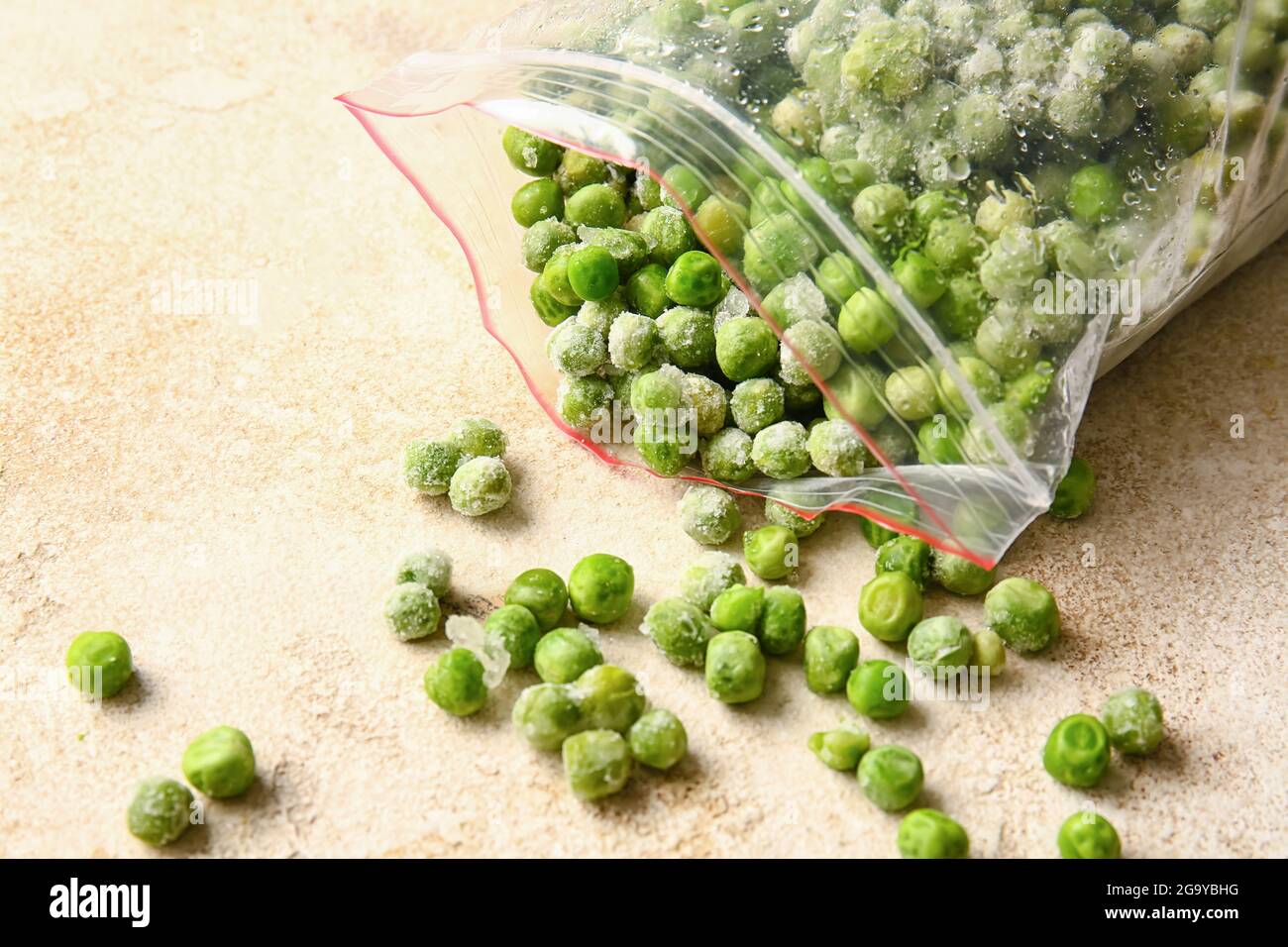 Bag with frozen green peas on light background Stock Photo - Alamy