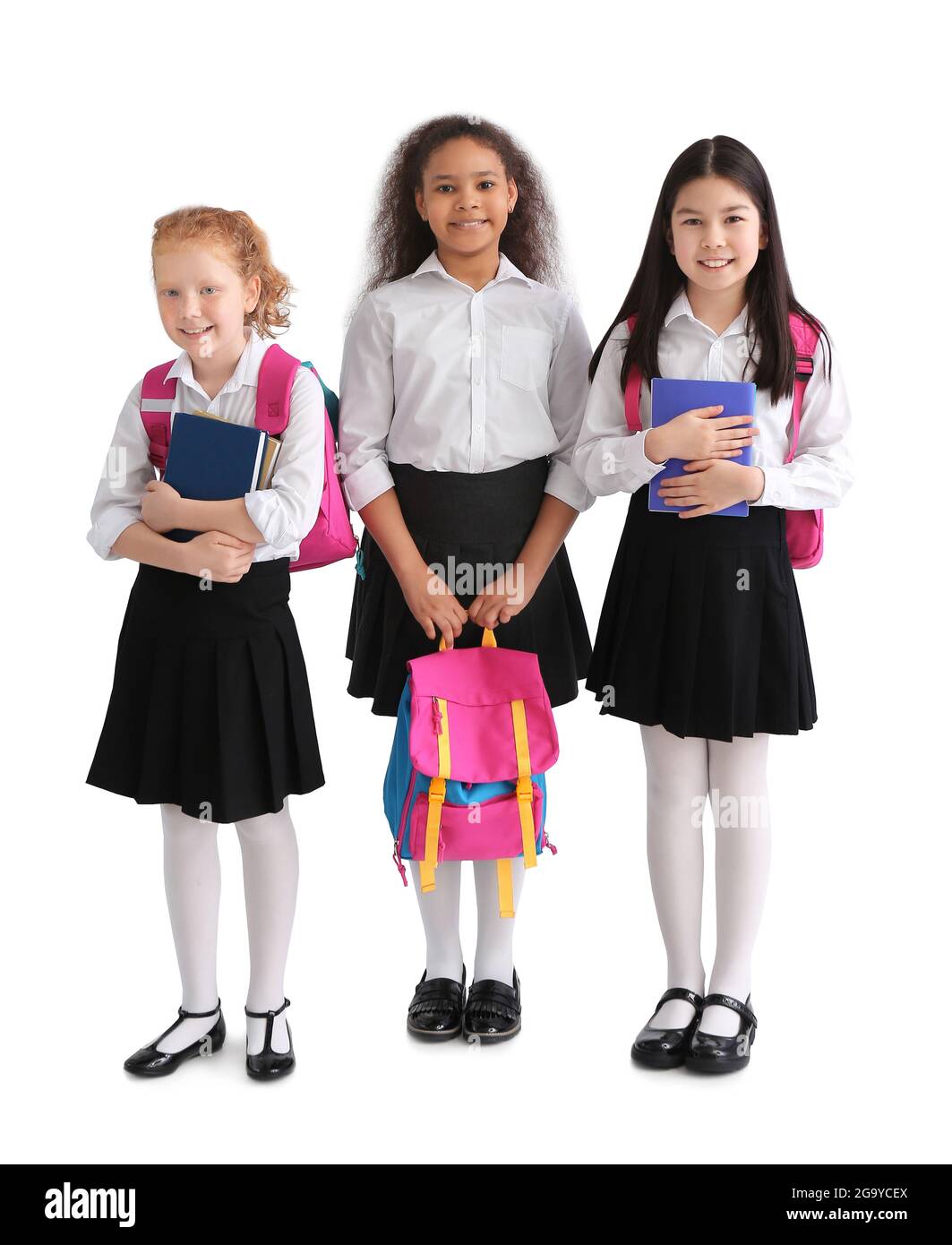Cute little schoolgirls on white background Stock Photo - Alamy