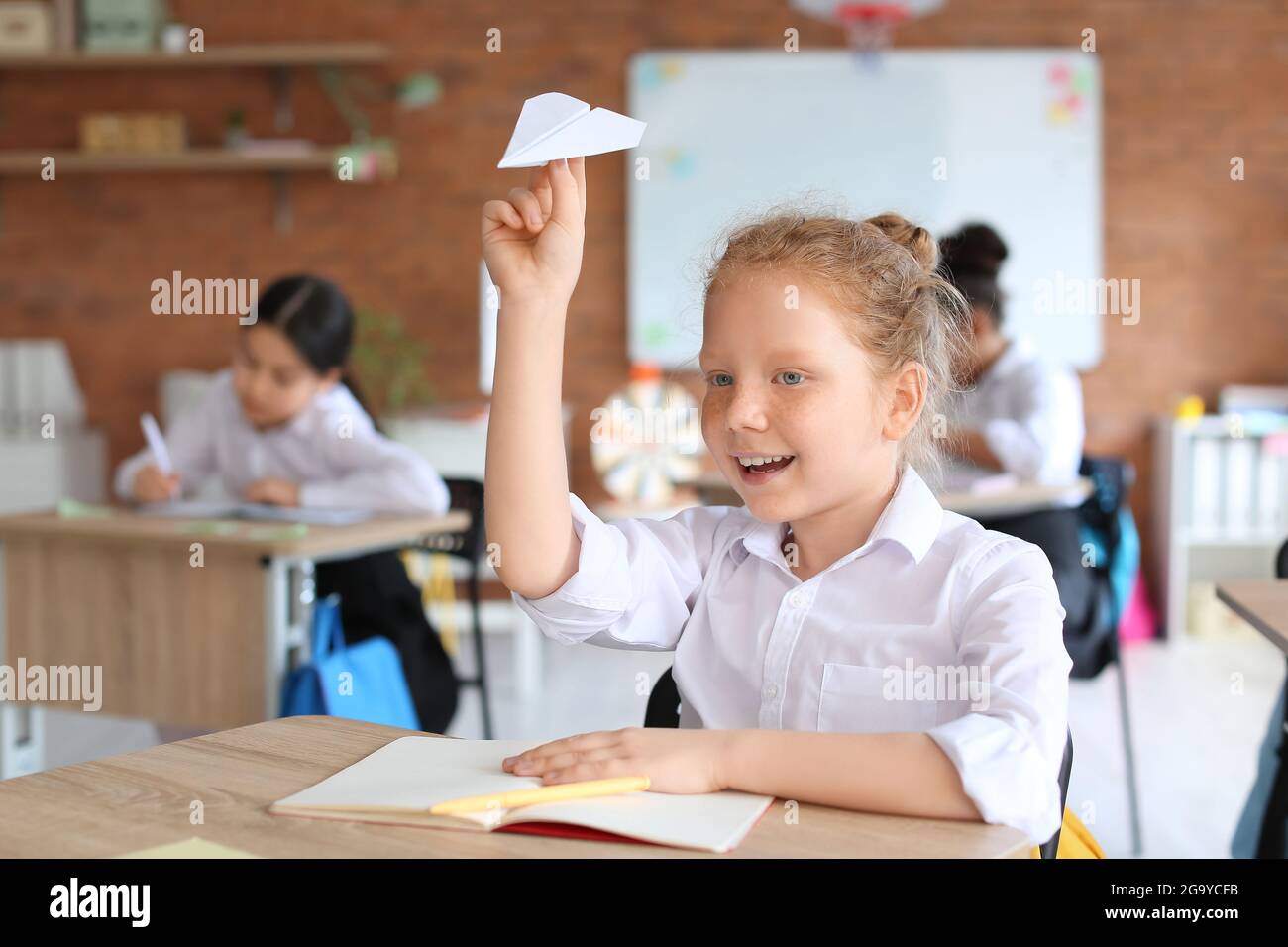 Cute little girl during lesson at school Stock Photo - Alamy