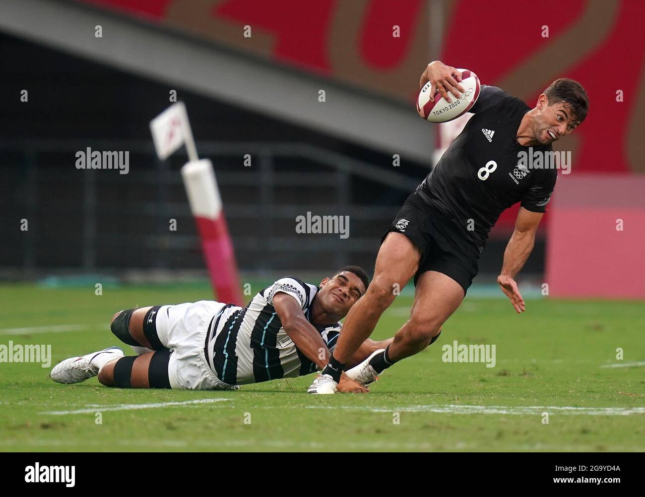 New Zealand's Andrew Knewstubb (right) is tackled by Fiji's Meli ...