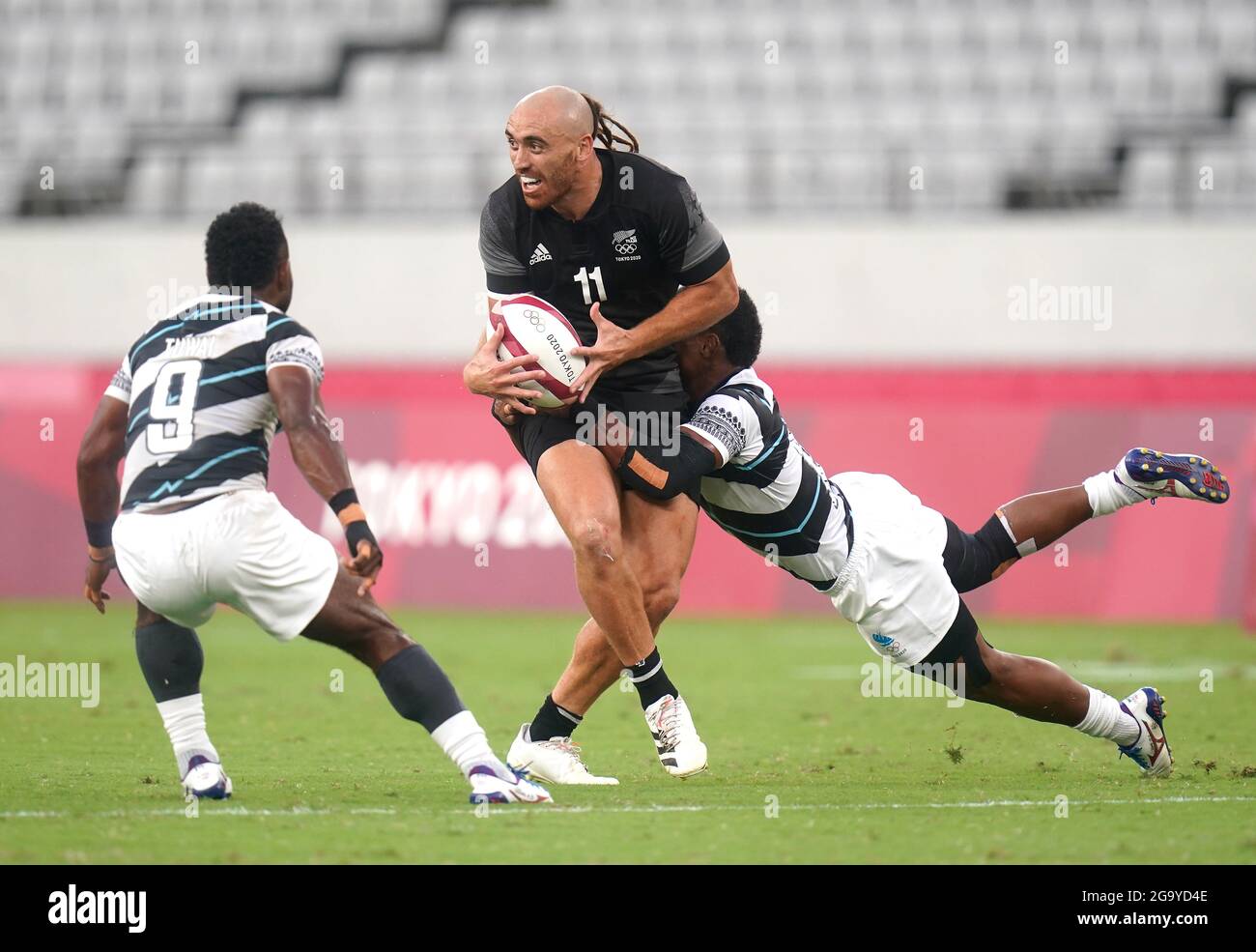 New Zealand's Joe Webber is tackled during the Men's Rugby Seven Gold ...