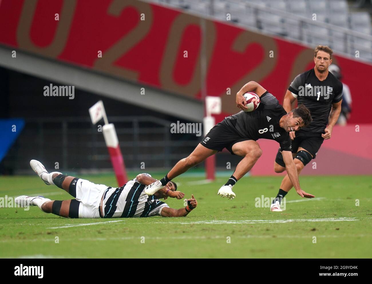 New Zealand's Andrew Knewstubb (right) is tackled by Fiji's Meli ...