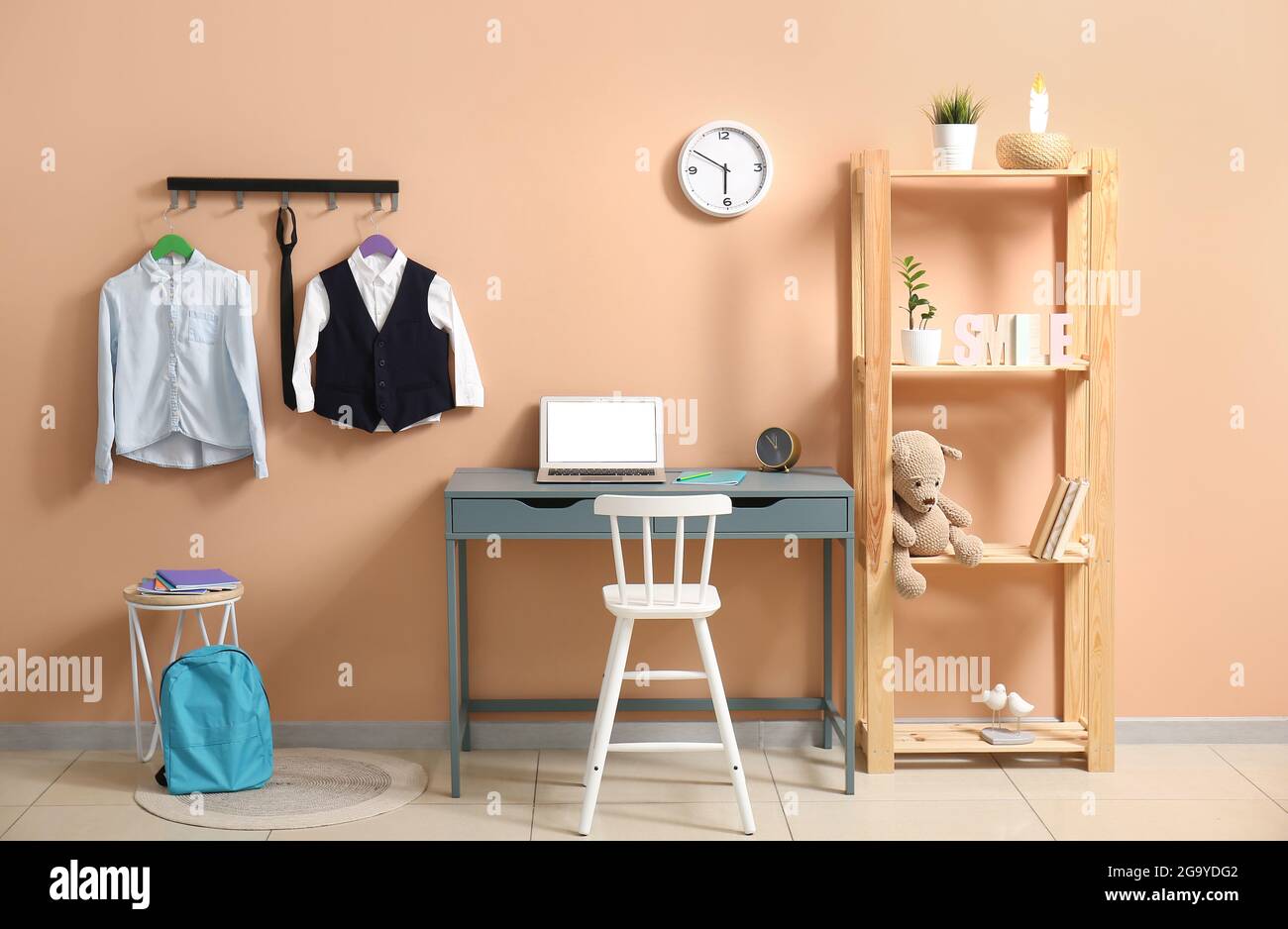 Interior of stylish room with modern workplace and school uniform Stock ...