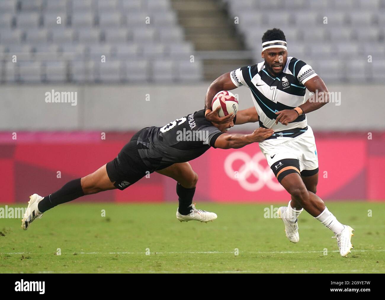 Fiji's Vilimoni Botitu (right) gets past New Zealand's Ngarohi McGarvey ...