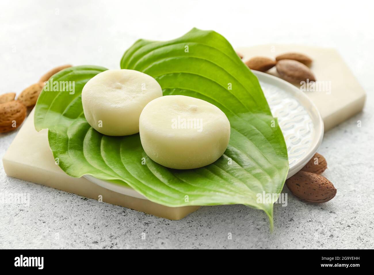 Tasty Japanese mochi and nuts on grey background Stock Photo - Alamy