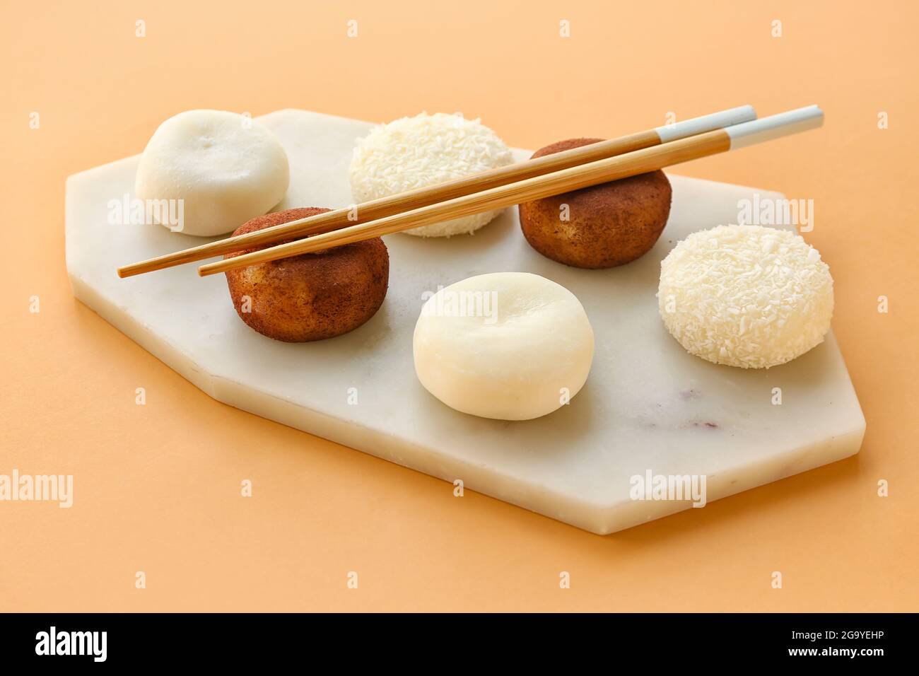 Board with tasty Japanese mochi on color background Stock Photo - Alamy