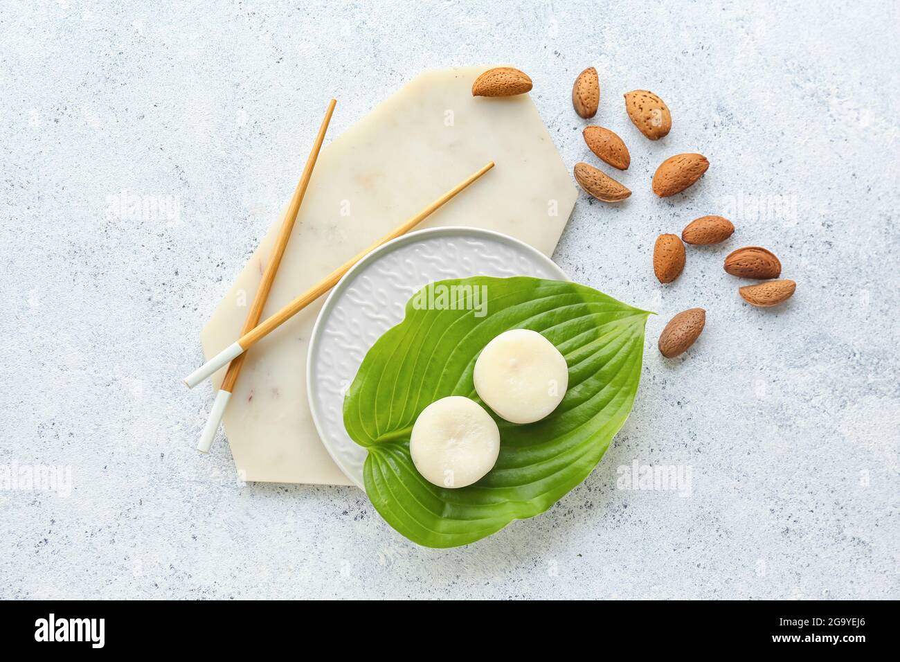 Tasty Japanese mochi and nuts on grey background Stock Photo - Alamy