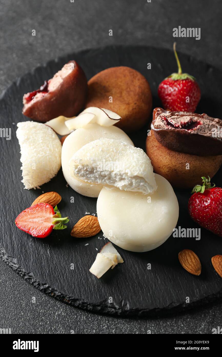 Slate plate with tasty Japanese mochi on dark background Stock Photo ...