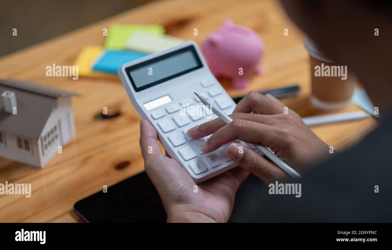 Man calculating financial chart for investment to buying property with ...