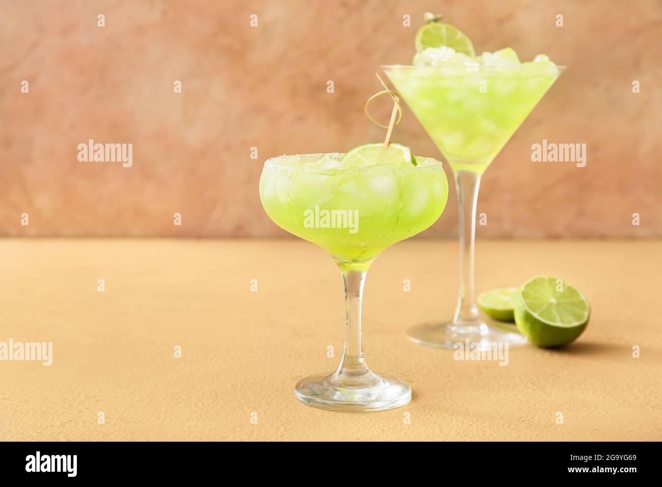 Glasses with tasty daiquiri cocktail on color background Stock Photo ...