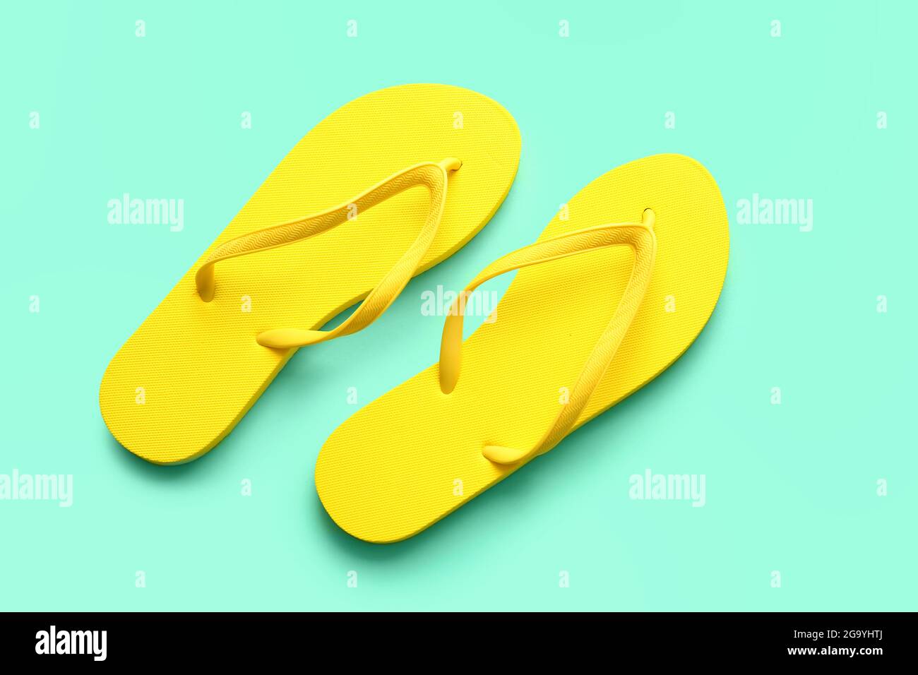 Stylish flip-flops on color background Stock Photo - Alamy