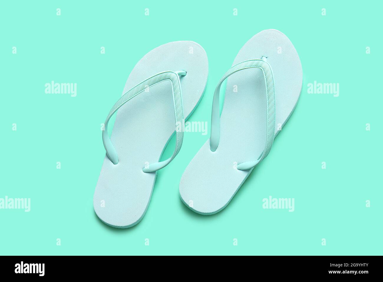 Stylish flip-flops on color background Stock Photo - Alamy
