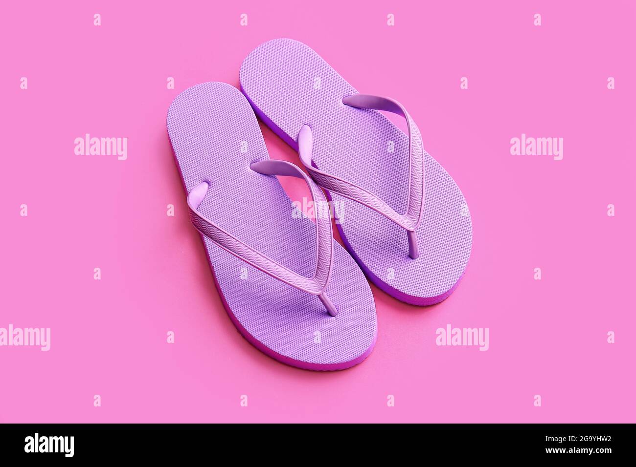 Stylish flip-flops on color background Stock Photo - Alamy