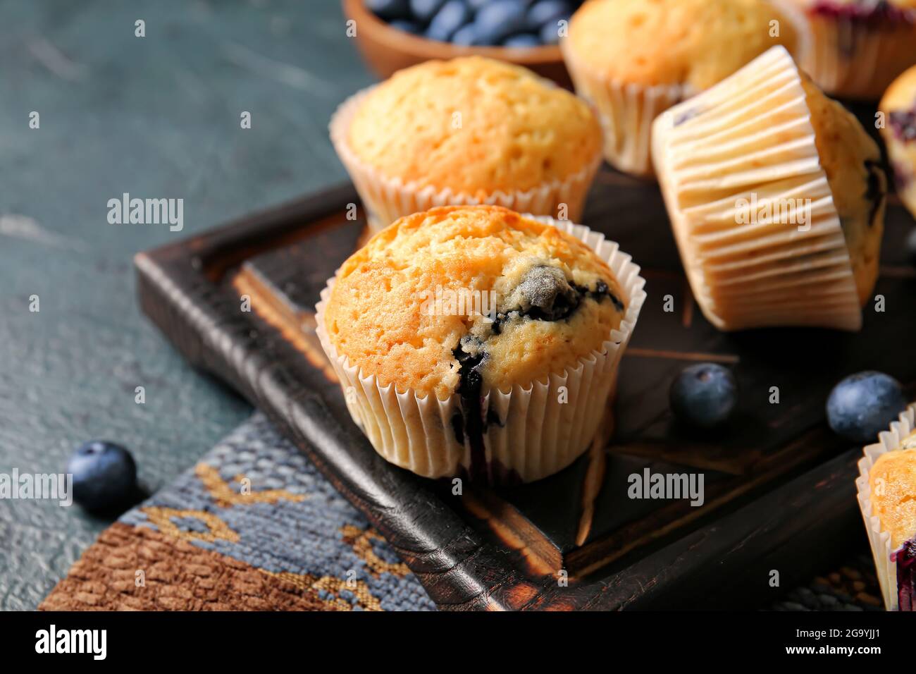 Tasty blueberry muffins on color background, closeup Stock Photo - Alamy