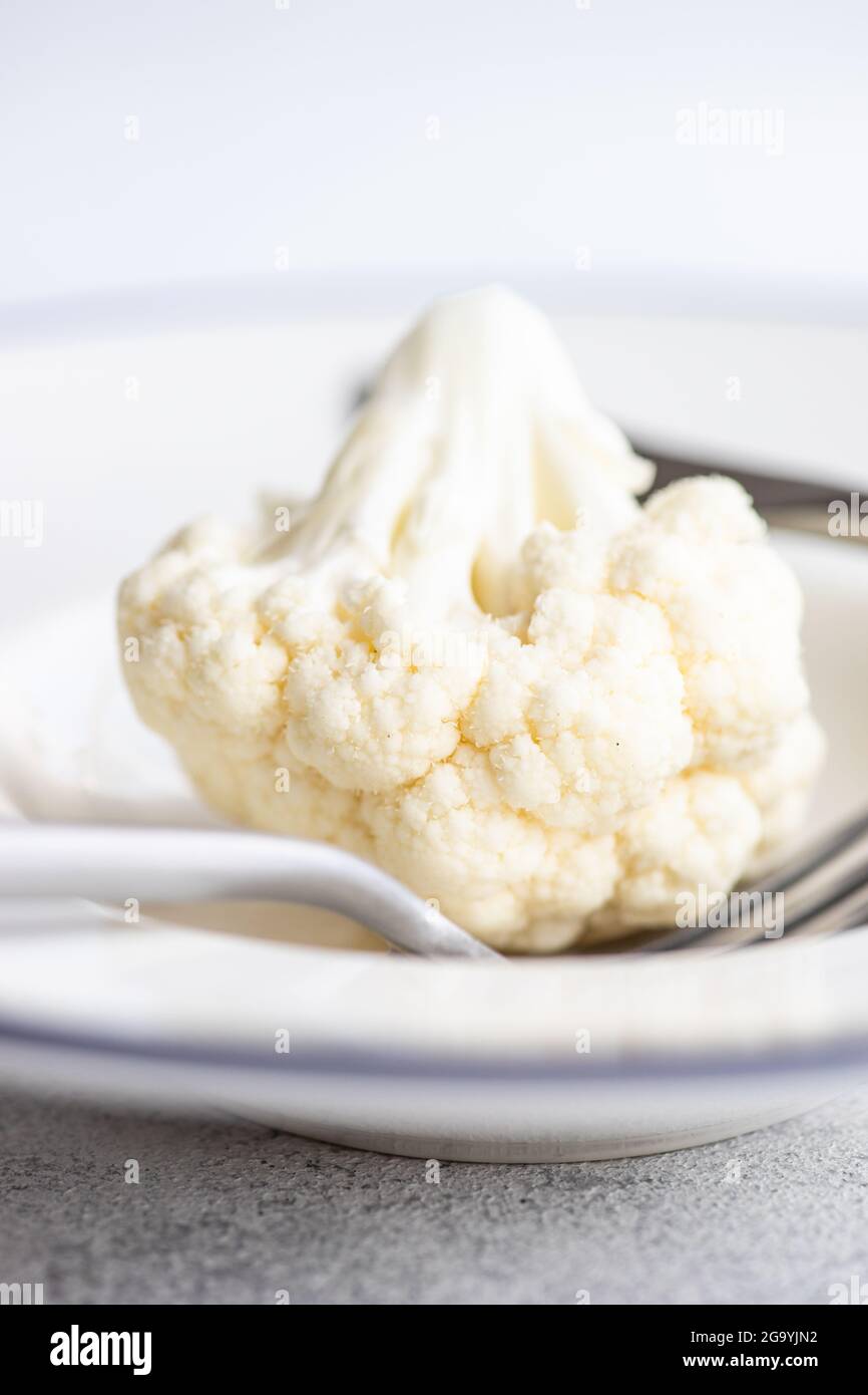 Close-up of a raw cauliflower floret on a plate Stock Photo - Alamy
