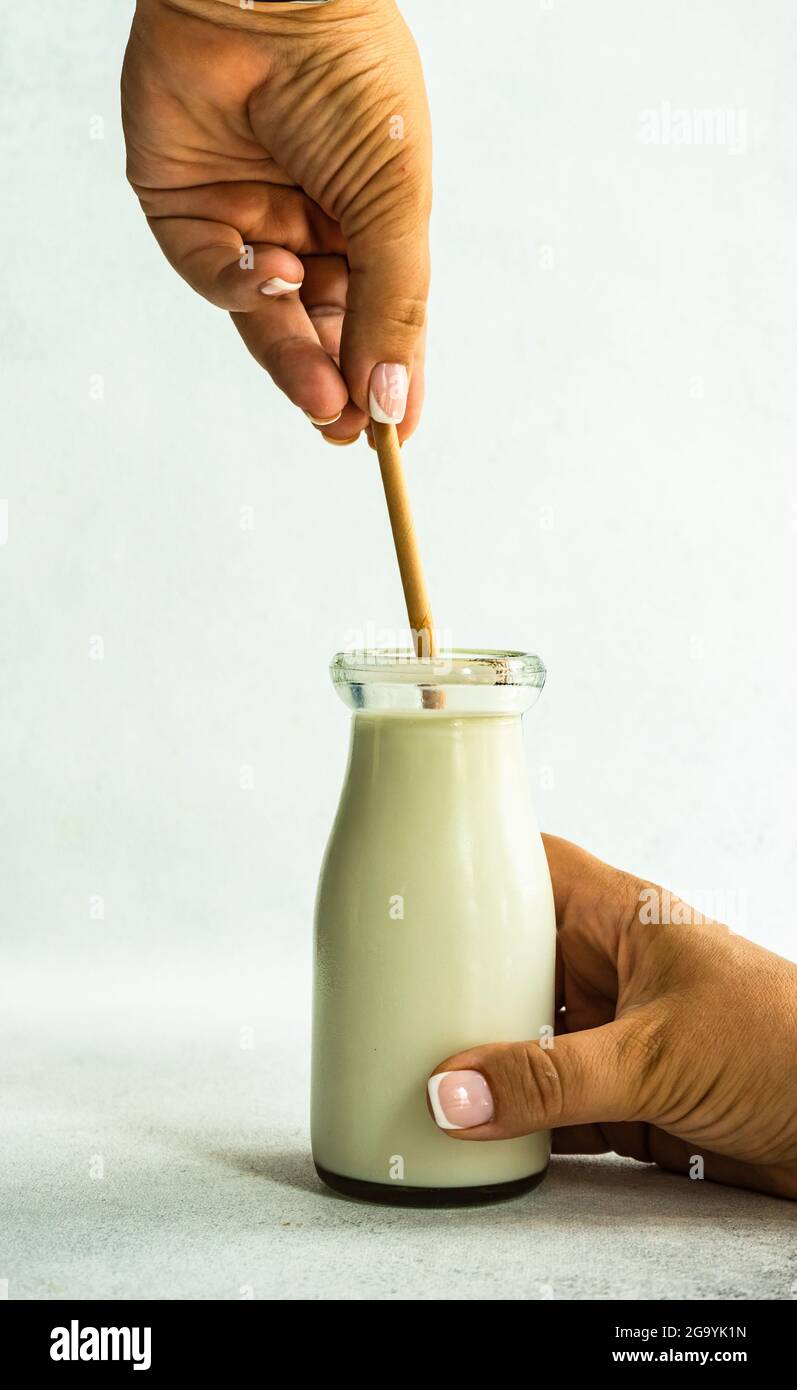 Woman stirring bottle milk hi-res stock photography and images - Alamy
