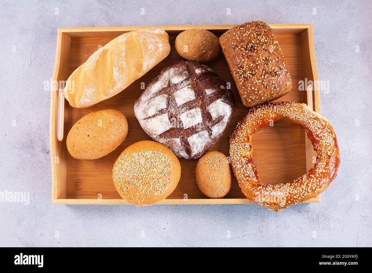 Different kinds of fresh bread on a tray. Bakery rustic homemade crisp ...
