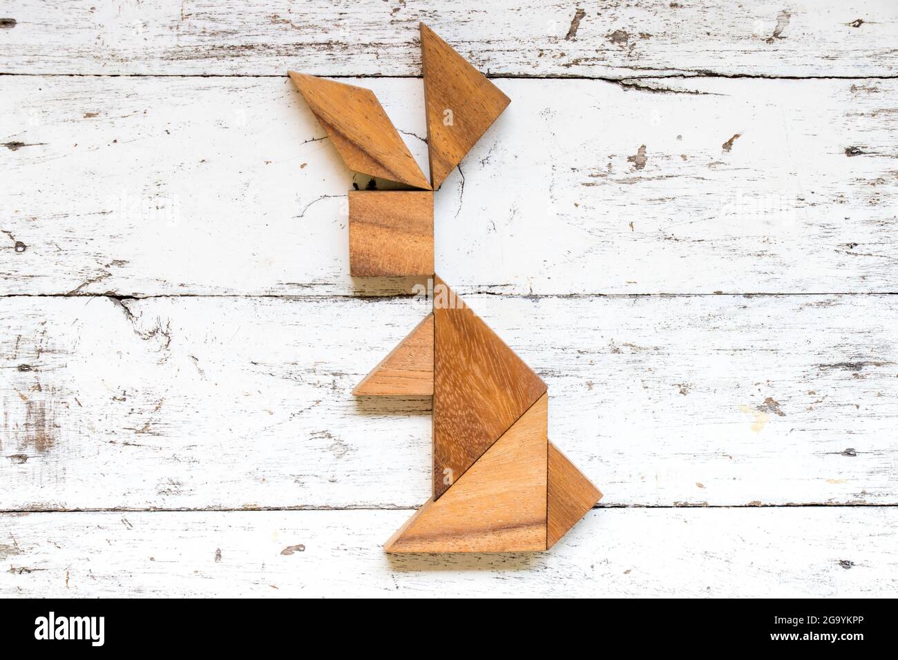 Tangram puzzle in rabbit shape on old white wood background Stock Photo ...