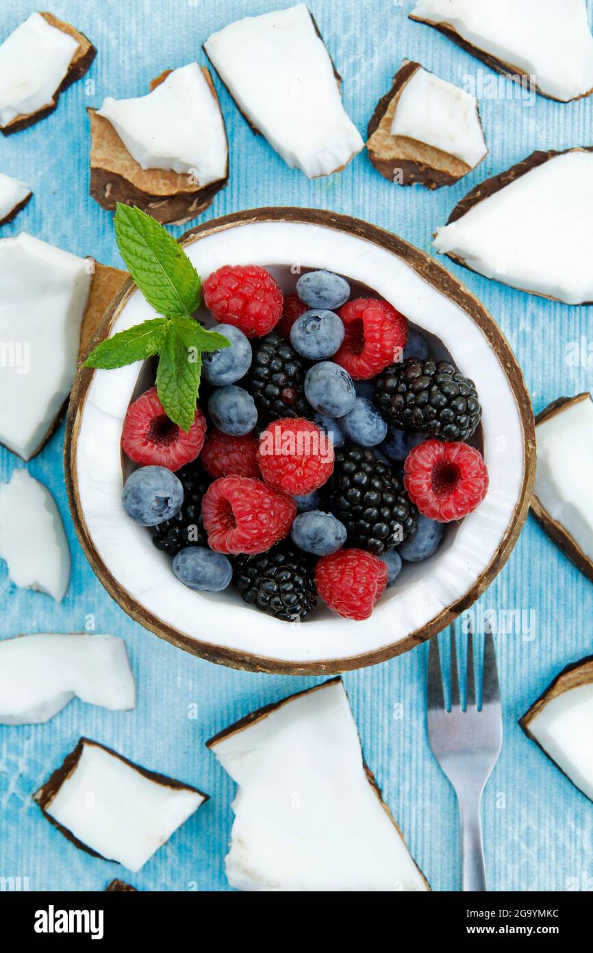 Coconut with berries Stock Photo - Alamy