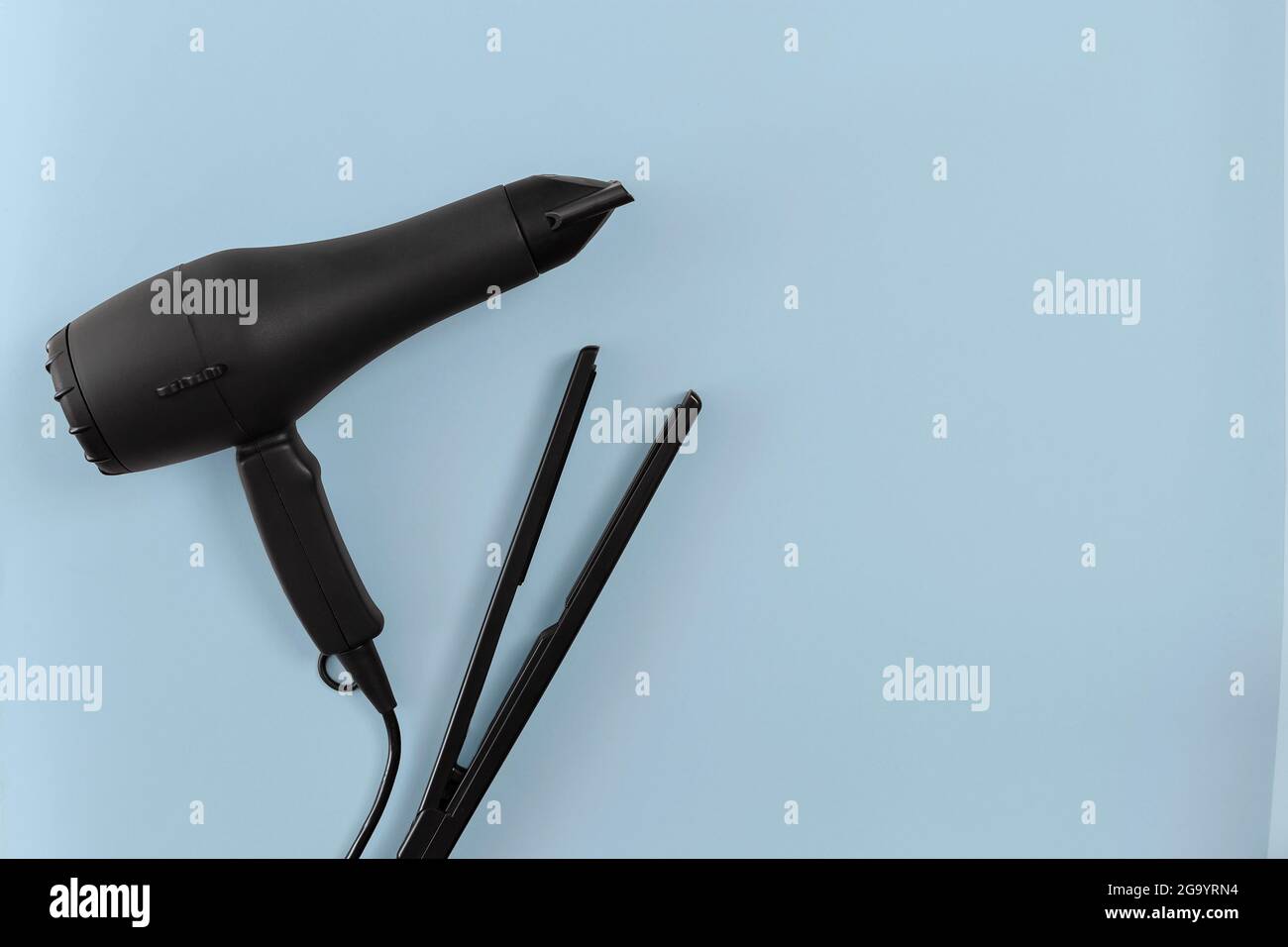 Various hair styling devices on blue paper background, top view Stock ...