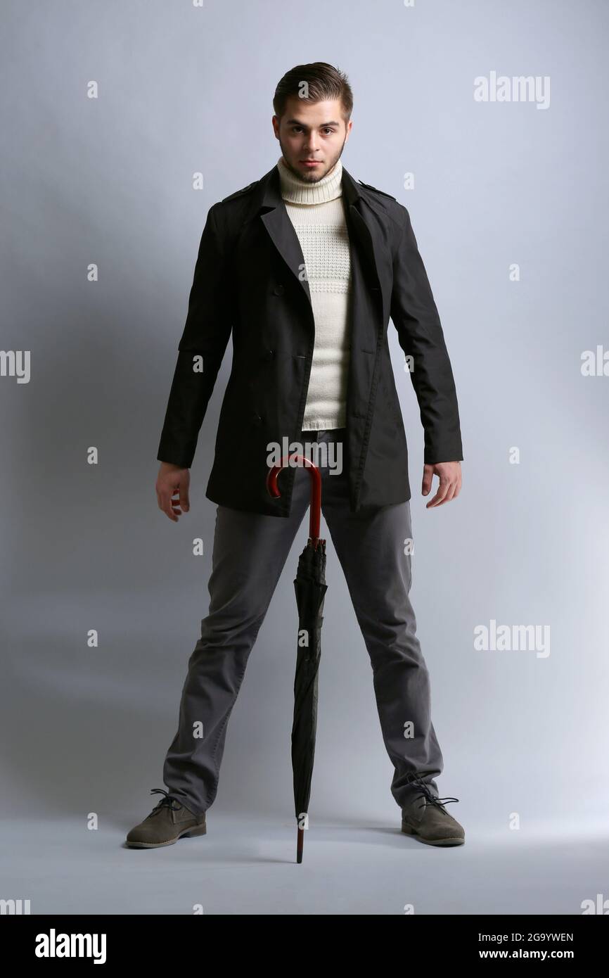 Elegant man with umbrella on gray background Stock Photo - Alamy