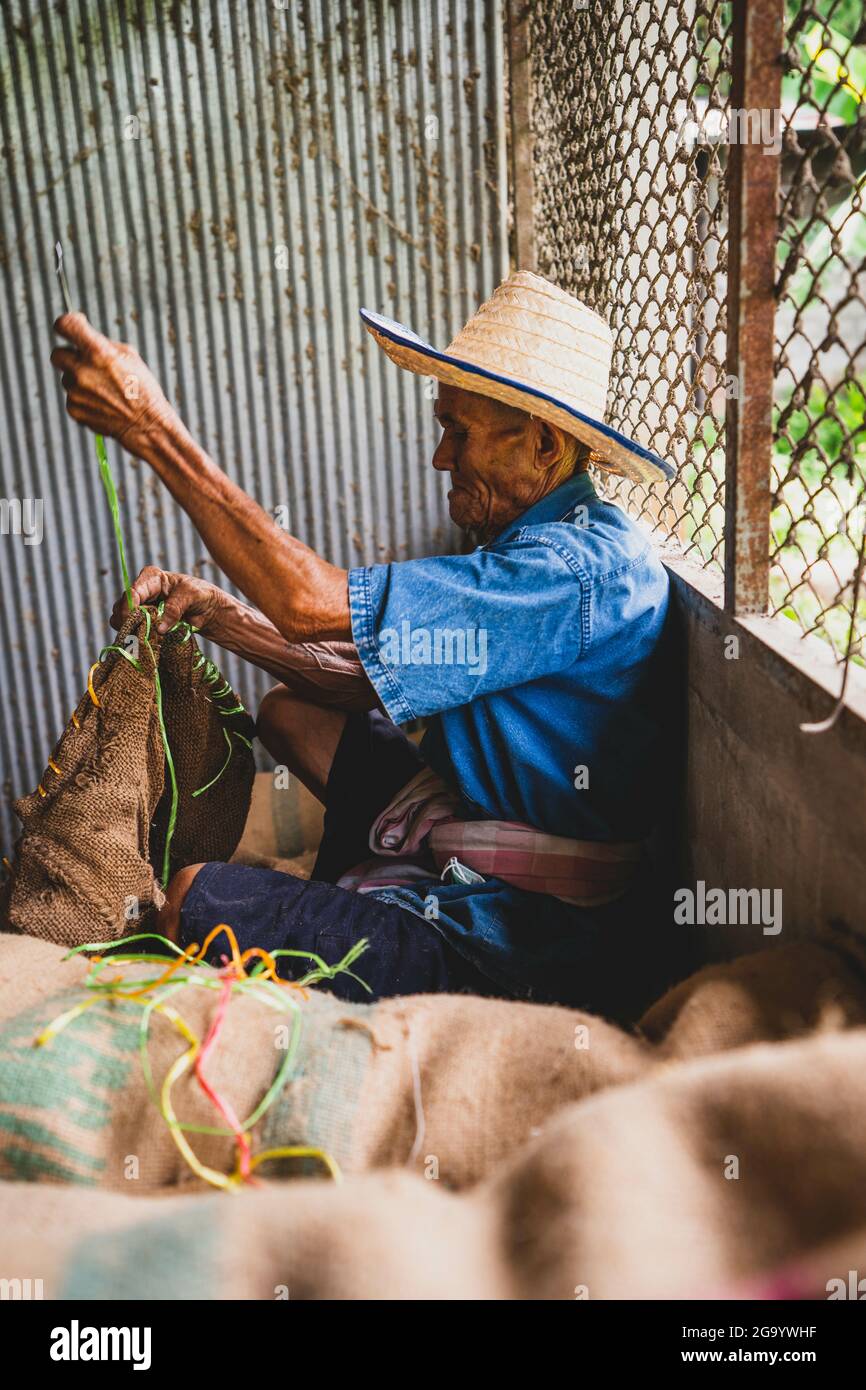 Man sewing bags hi-res stock photography and images - Alamy