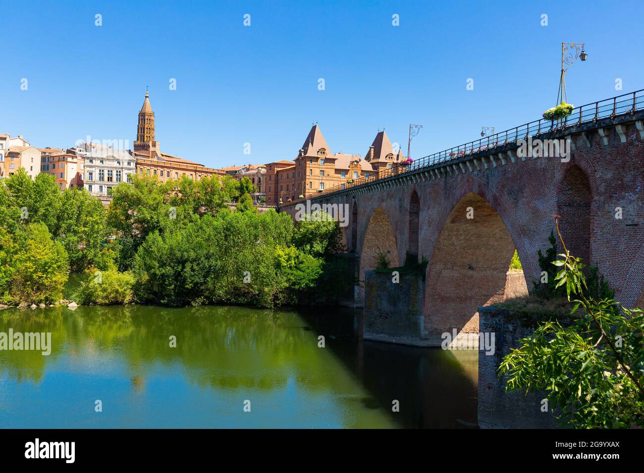 Montauban city on sunny day. Medieval bridge over the Tarn river Stock ...