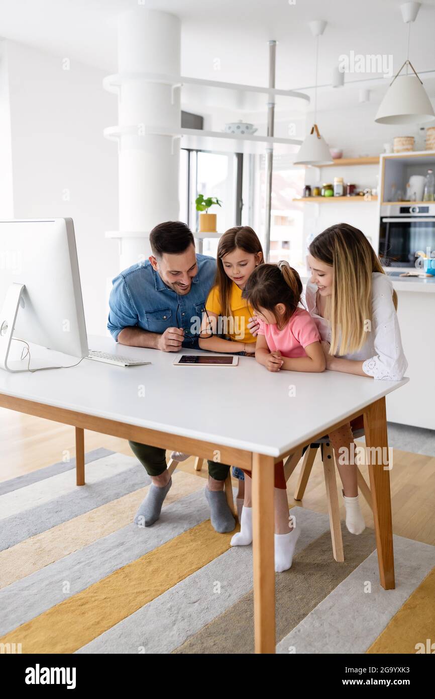 Online school, technology, family concept. Happy parents helping to ...